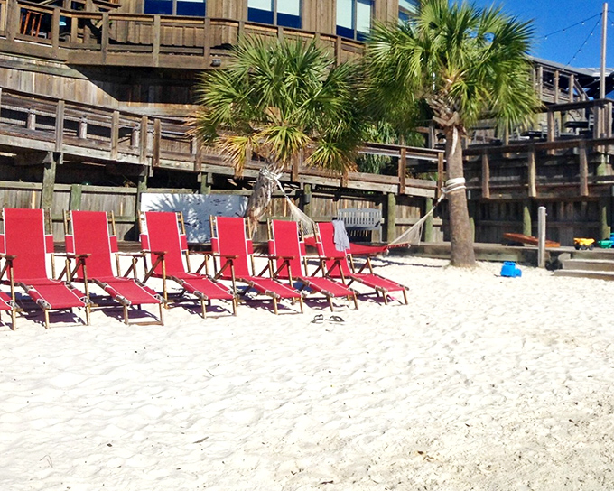 Those iconic red beach chairs aren't just for show&mdash;they're your front-row seats to the Gulf's greatest performance while you wait for your table.