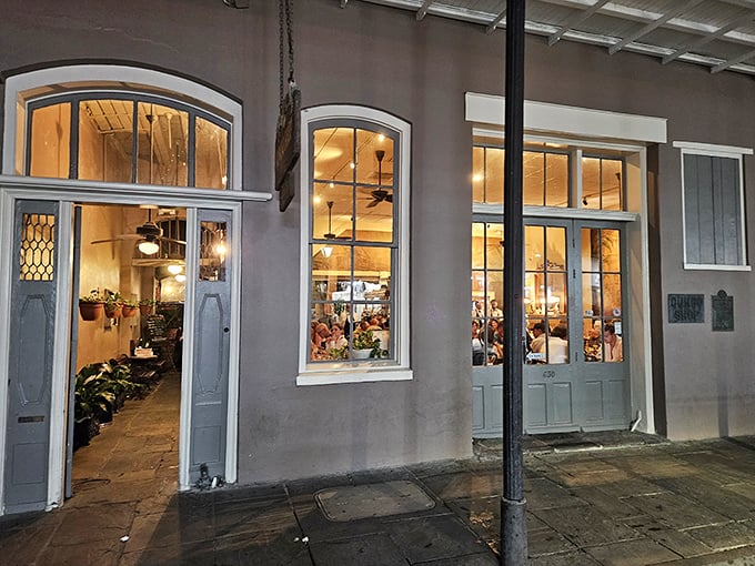 Evening glow spills from the Gumbo Shop's windows, beckoning hungry souls like moths to the flame of Creole cuisine.