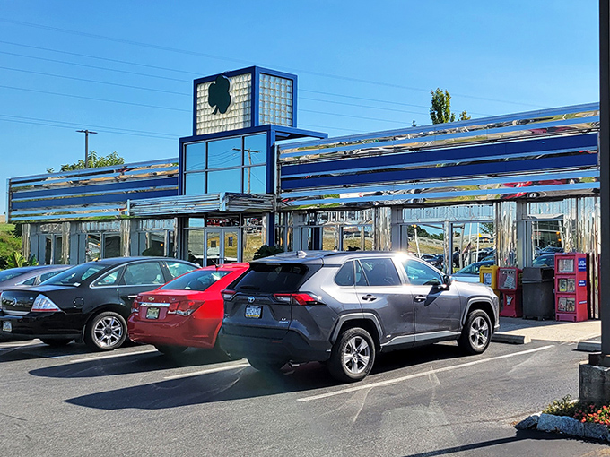 The neon-trimmed exterior of Lyndon Diner glows like a beacon for hungry travelers, its iconic green clover sign promising good luck and better breakfasts.