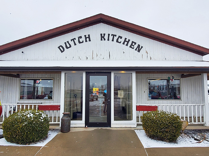 The unassuming white exterior of Dutch Kitchen welcomes hungry travelers like a beacon of breakfast hope in Amish Country, promising homestyle cooking without pretension.
