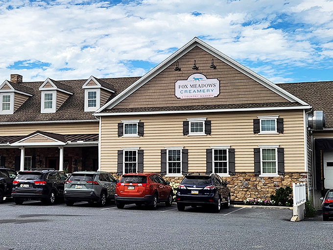 The charming farmhouse exterior of Fox Meadows Creamery stands proudly against Pennsylvania's blue skies, promising dairy delights that would make a cow blush with pride.