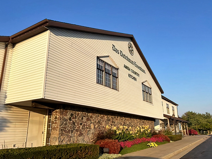 The iconic yellow siding and stone foundation of Das Dutchman Essenhaus stands like a beacon of comfort food in Middlebury, promising culinary salvation to hungry travelers.