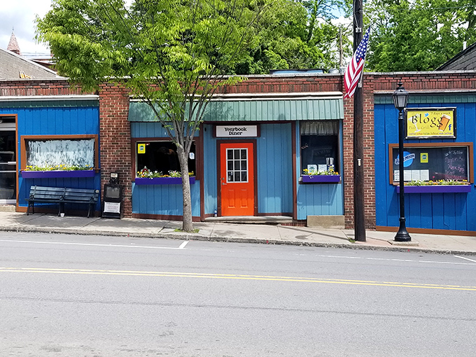 The unassuming blue exterior with that bright orange door is like a secret handshake &ndash; those who know, know this is where breakfast dreams come true.