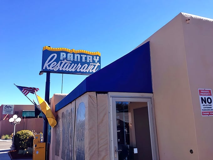 That iconic blue awning and vintage sign against the New Mexico sky &ndash; like a beacon calling all hungry travelers home.