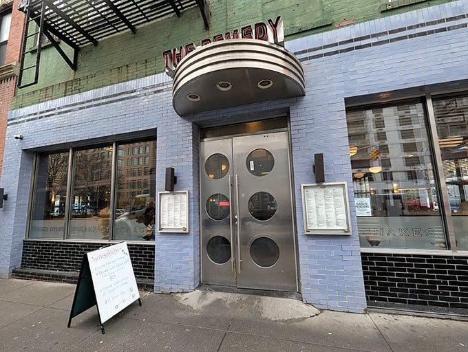 The blue-brick facade of Remedy Diner beckons like a portal to simpler times, complete with those iconic round porthole windows that practically wink at passersby.