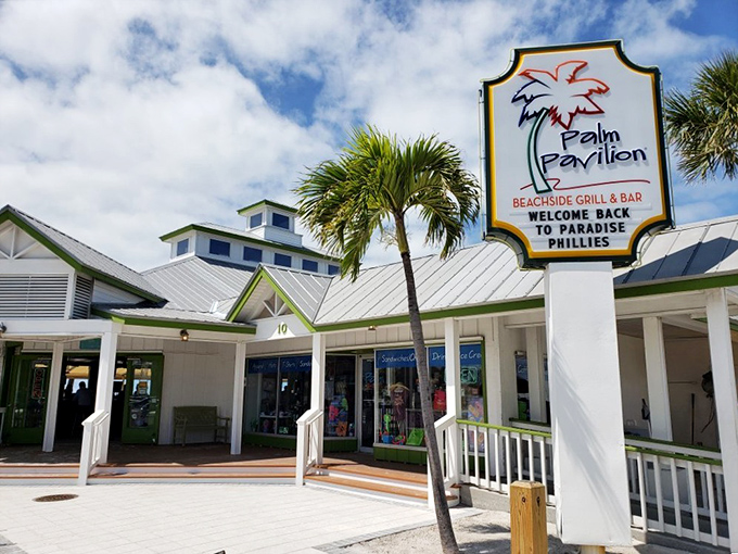 Paradise found! The iconic Palm Pavilion sign welcomes beach-goers with its cheerful colors and promise of Florida relaxation just steps from the sand.
