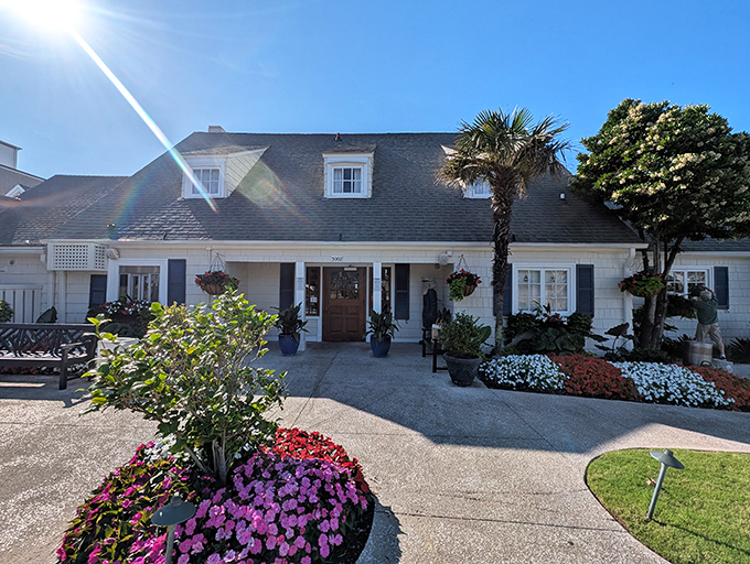 The Sea Captain's House stands like a defiant time traveler among Myrtle Beach's high-rises, its flower-lined entrance promising coastal charm before you even reach the door.