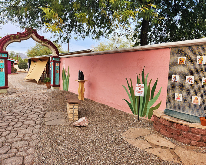 The entrance to Govinda's feels like stepping into a secret garden oasis, complete with desert blooms and a welcoming archway that promises culinary adventures ahead.