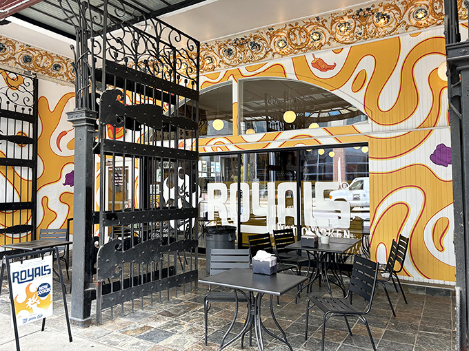 The vibrant exterior screams "food adventure ahead!" with its playful crown logo and bold orange swirls&mdash;Louisville's artistic spirit meets Nashville heat.