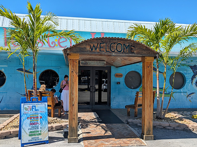 The turquoise beacon of culinary delight beckons with its wooden "WELCOME" sign &ndash; a humble entrance hiding extraordinary flavors within.