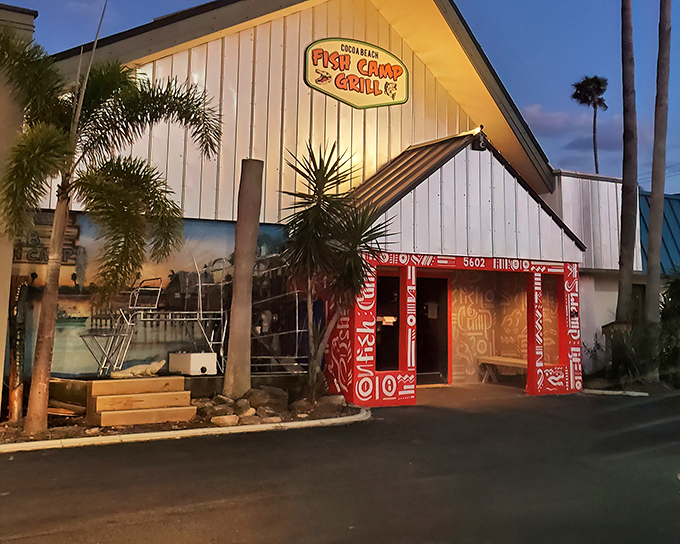 The white A-frame exterior with its vibrant red doorway isn't just inviting&mdash;it's practically shouting "Get in here and eat something delicious!" Pure Florida charm at sunset.