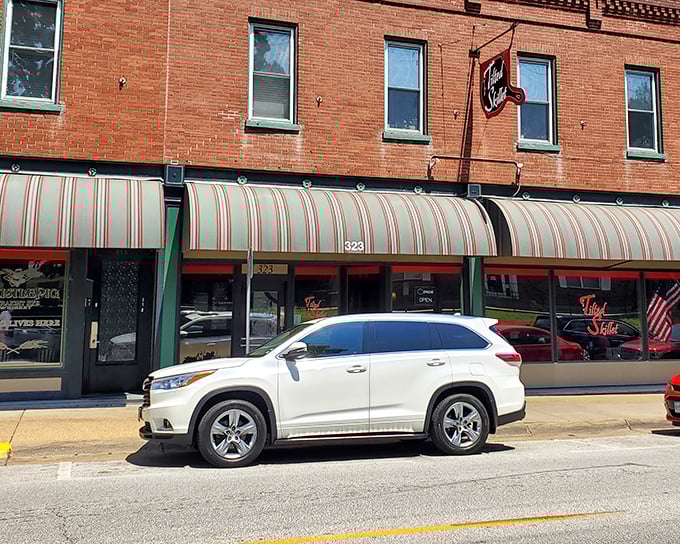 The unassuming brick exterior of The Tilted Skillet hides culinary treasures within. Like all great food stories, this one begins behind a modest striped awning.