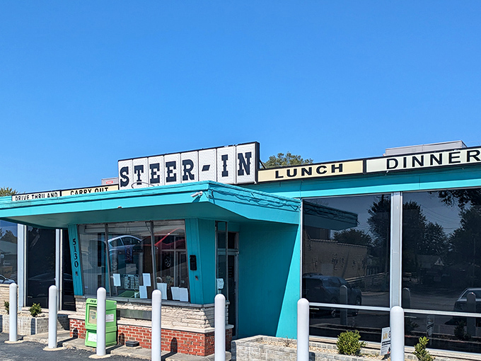 The turquoise time machine beckons! Steer-In's iconic exterior stands proudly against the Indiana sky, promising comfort food that transcends decades.