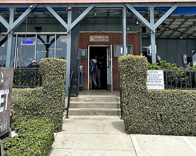 That weathered sign promises adventure &ndash; Neptune's Net delivers oceanic treasures without the pretense of fancier establishments.