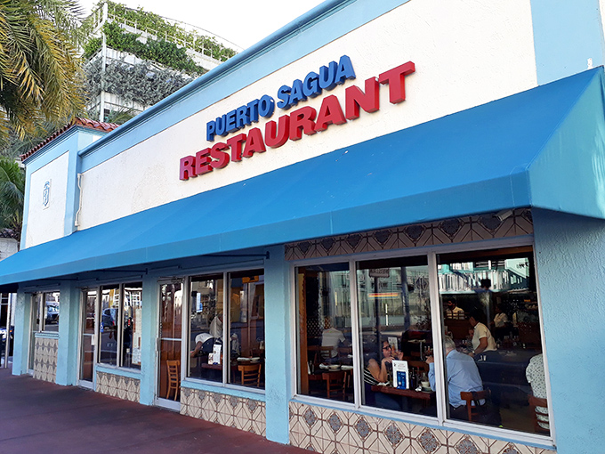 The unassuming exterior hides decades of Cuban culinary magic, complete with palm trees standing guard like delicious sentinels.