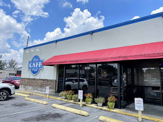 The unassuming exterior of Blue Plate Cafe in Huntsville - where pancake dreams come true behind that cheerful red awning.