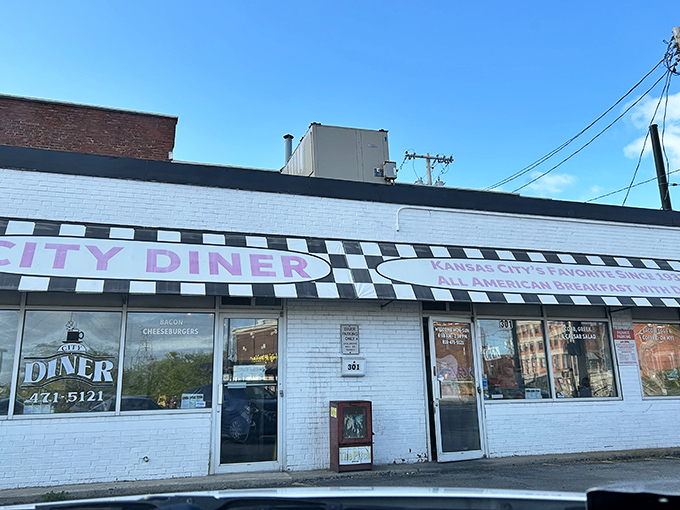 The checkered facade of City Diner stands like a culinary lighthouse on Grand Boulevard, beckoning hungry souls with promises of breakfast nirvana.