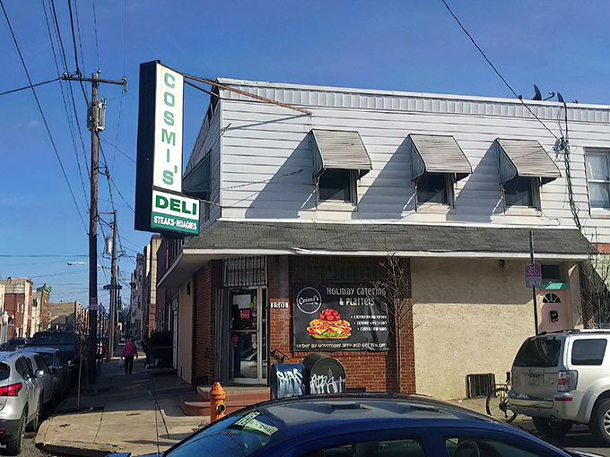 The unassuming exterior of Cosmi's Deli stands like a culinary speakeasy in South Philly, where sandwich greatness hides behind modest white siding and a simple green sign.