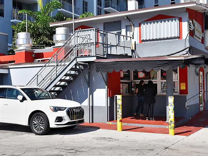 The unassuming exterior that hides culinary greatness. Like finding a Picasso at a yard sale, this red and white facade conceals Miami's sandwich paradise.