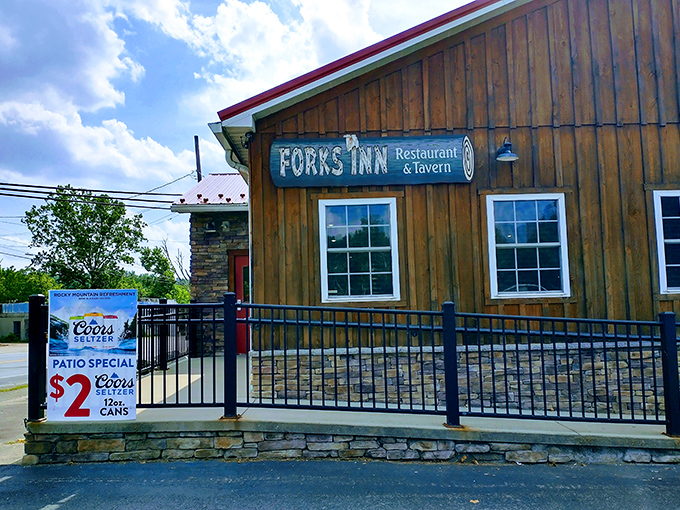 The rustic wooden facade of Forks Inn welcomes hungry travelers with its promise of comfort food and cold drinks in Pennsylvania's scenic Laurel Highlands.