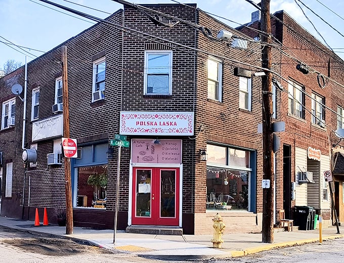 The unassuming brick corner building with its vibrant red doors beckons like a secret Polish embassy in Pittsburgh's urban landscape.