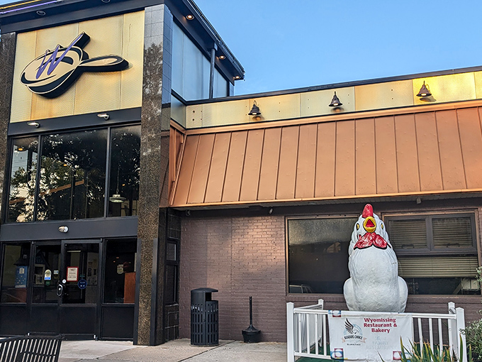 The iconic Wyomissing Restaurant and Bakery exterior, complete with that whimsical chicken statue standing guard. Pennsylvania comfort food has found its fortress.
