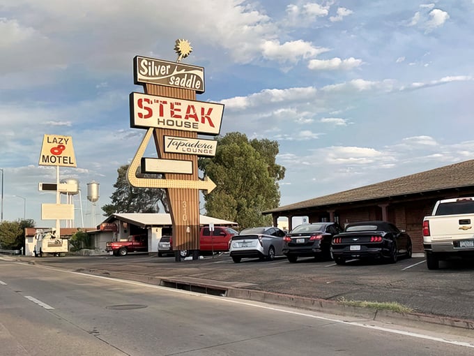 That vintage sign isn't just advertising &ndash; it's a beacon of hope for the hungry. Mesquite-broiled promises under the Arizona sky.