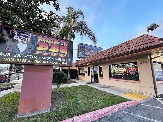 The iconic Smoking Pig BBQ sign beckons hungry travelers like a smoky lighthouse guiding ships to delicious shores. That cartoon pig knows what you're in for!