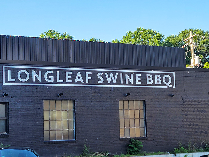 The unassuming black brick exterior of Longleaf Swine is like a secret clubhouse for barbecue aficionados &ndash; no flash, all substance.