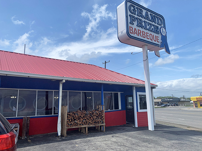 That iconic red roof and blue trim announces you've arrived at barbecue heaven. The woodpile isn't decoration&mdash;it's a promise.