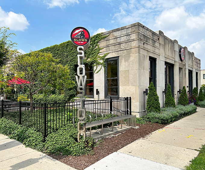 The stone fortress of flavor! Slows To Go's ivy-covered exterior with its iconic vertical sign promises barbecue nirvana in Detroit's Corktown neighborhood.