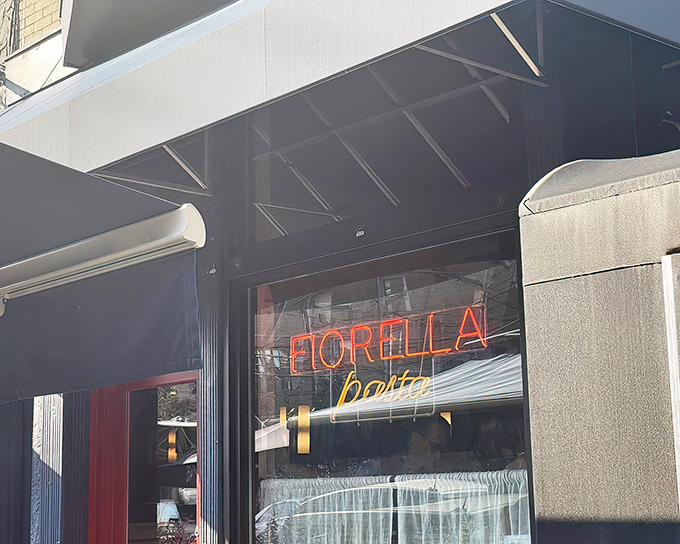 The glowing neon sign beckons like a lighthouse for pasta pilgrims. Fiorella's entrance promises treasures that Italian grandmothers would approve of.