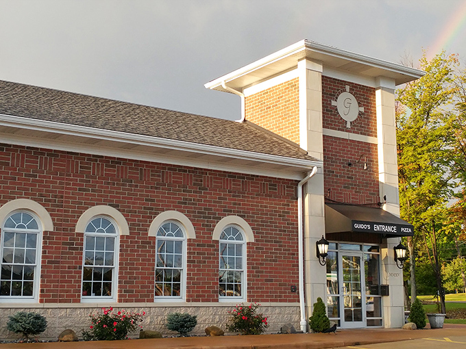 Guido's brick façade with its distinctive clock tower stands like a culinary lighthouse, beckoning hungry travelers with the promise of Italian comfort.