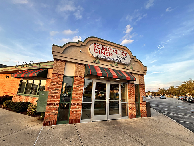 The brick facade and striped awnings of Round the Clock Diner - East stand like a beacon of comfort food promise in York's landscape.
