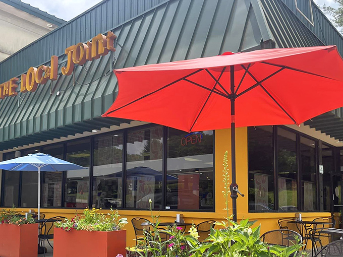 The Local Joint's exterior welcomes you with cheerful yellow accents and colorful umbrellas &ndash; like a culinary lighthouse beckoning hungry travelers to safe harbor.