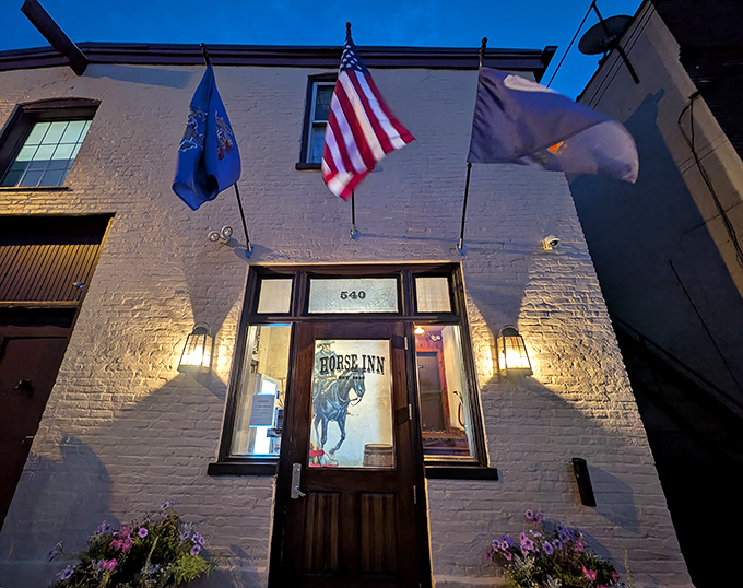 The white brick fa&ccedil;ade of Horse Inn glows with welcome, flags fluttering above like a beacon to hungry travelers seeking culinary adventure in Lancaster.