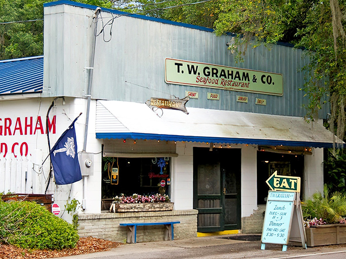 The blue metal exterior with "God Bless Our Shrimpers" chalked on the window tells you everything: this isn't fancy, but it's the real South Carolina deal.