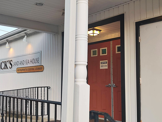 The unassuming entrance to Beck's Land & Sea House proves that extraordinary culinary experiences often hide behind ordinary doors. That red door? It's practically a portal to seafood paradise.