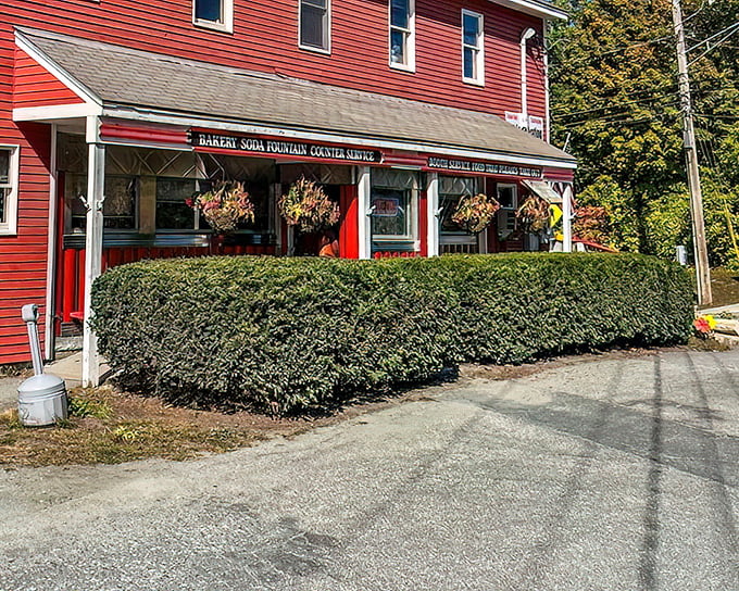 The classic red exterior of Four Aces Diner stands like a time capsule in West Lebanon, promising comfort food that predates your smartphone addiction.