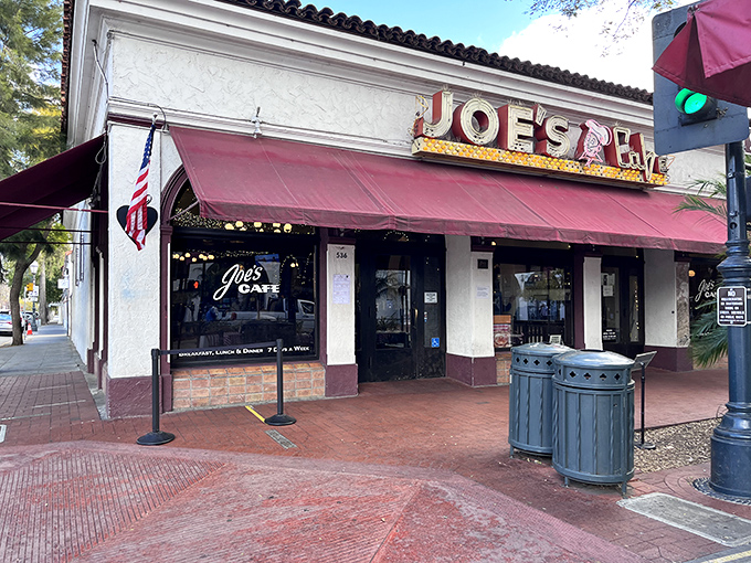 The iconic red awning of Joe's Caf&eacute; beckons hungry travelers like a culinary lighthouse on Santa Barbara's State Street.