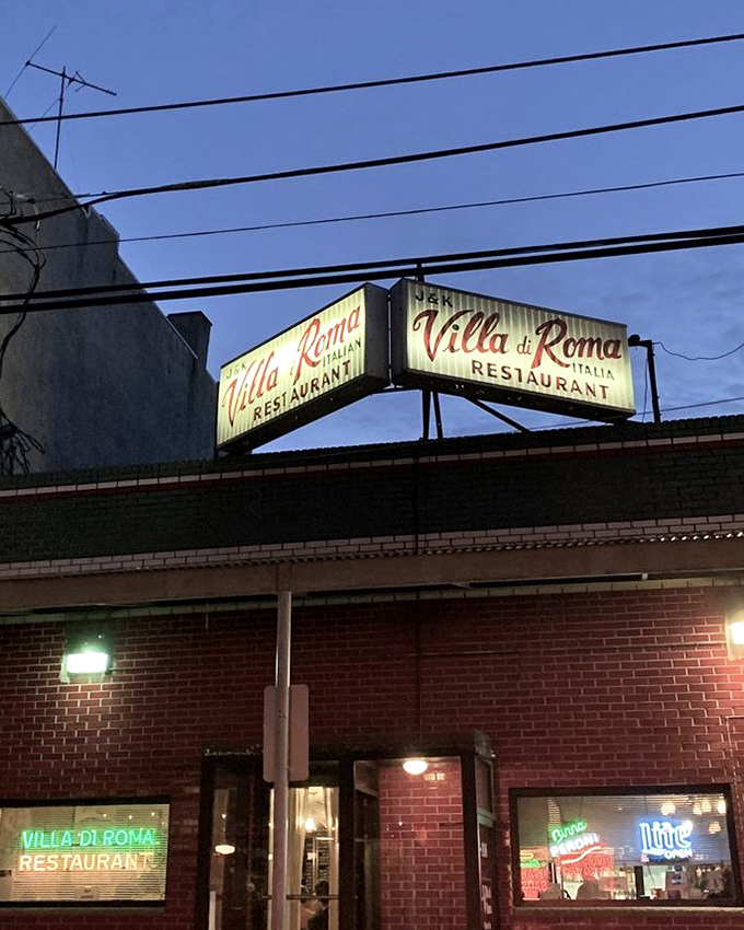 The iconic Villa di Roma sign glows like a beacon in Philadelphia's Italian Market, promising culinary traditions that have stood the test of time.