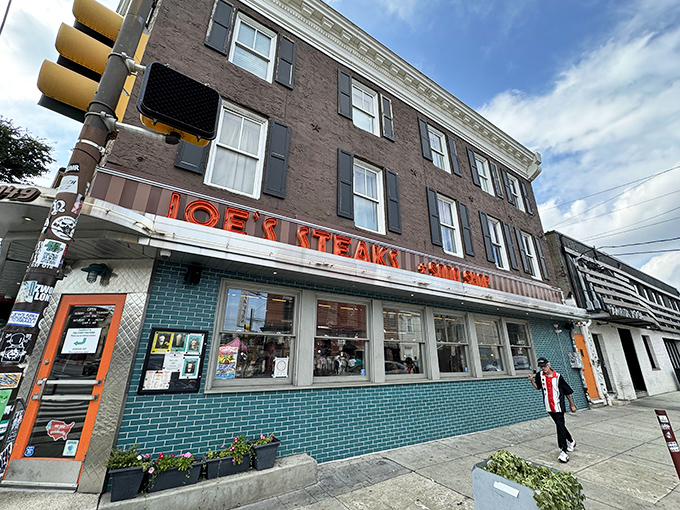 The iconic turquoise-tiled exterior of Joe's Steaks + Soda Shop stands as a beacon of culinary nostalgia in Fishtown, promising delicious adventures within those retro walls.