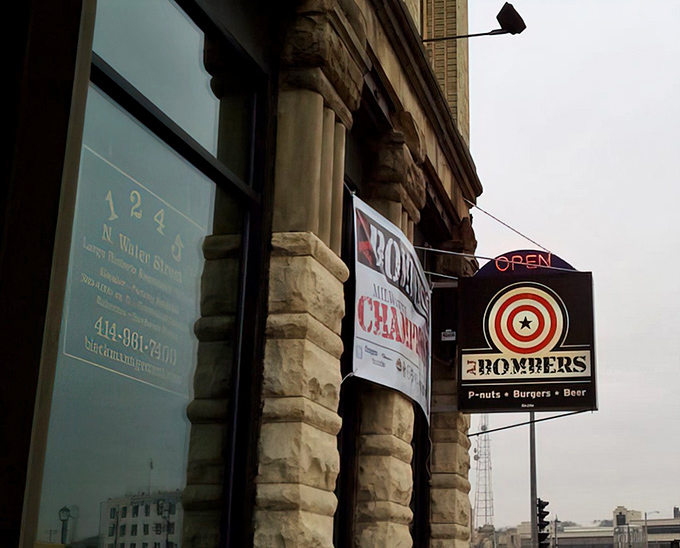 The historic stone facade of AJ Bombers stands like a culinary fortress, its target-logo sign promising a direct hit to your hunger pangs.