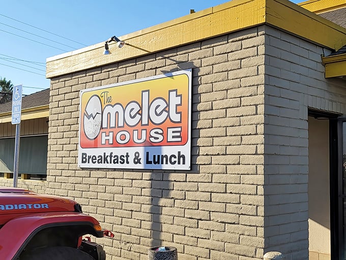 The unassuming exterior of The Omelet House proves that culinary treasures often hide behind the simplest facades. That cheerful egg mascot knows what's up!