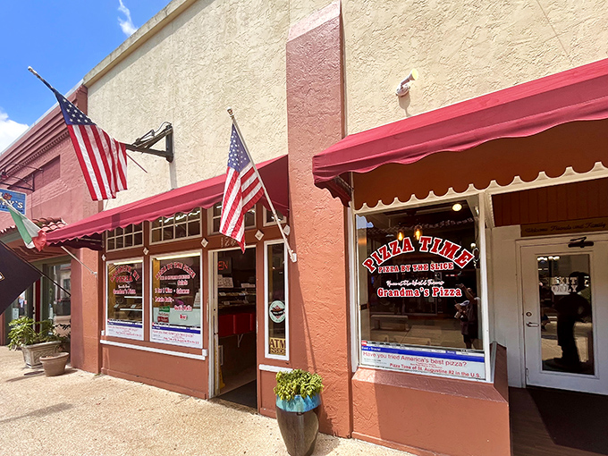 Pizza Time's charming storefront stands as a beacon for pizza lovers. The Italian and American flags hint at the authentic flavors within.