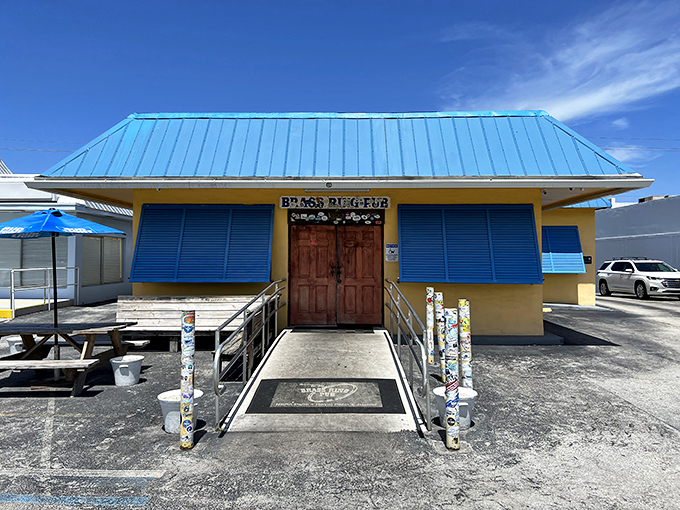 The unassuming yellow exterior with bright blue trim might fool you, but locals know this modest building houses wing perfection. Florida's best-kept culinary secret hides in plain sight.