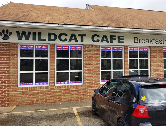 That iconic paw print logo welcomes hungry visitors to this brick-faced treasure, where "OPEN" signs glow like beacons of breakfast hope.