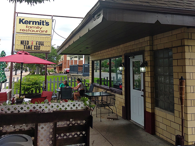 The iconic yellow brick exterior of Kermit's welcomes hungry travelers with its charming patio and promise of home-cooked comfort.