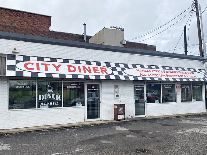 The checkered facade of City Diner stands like a culinary lighthouse on Grand Boulevard, beckoning hungry souls with promises of breakfast nirvana.