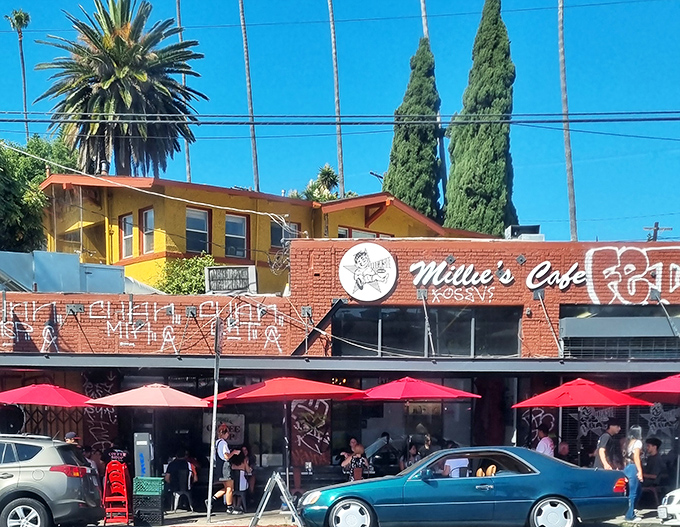 The cheerful yellow and brick exterior of Millie's Cafe stands out like a breakfast beacon against the California blue sky.